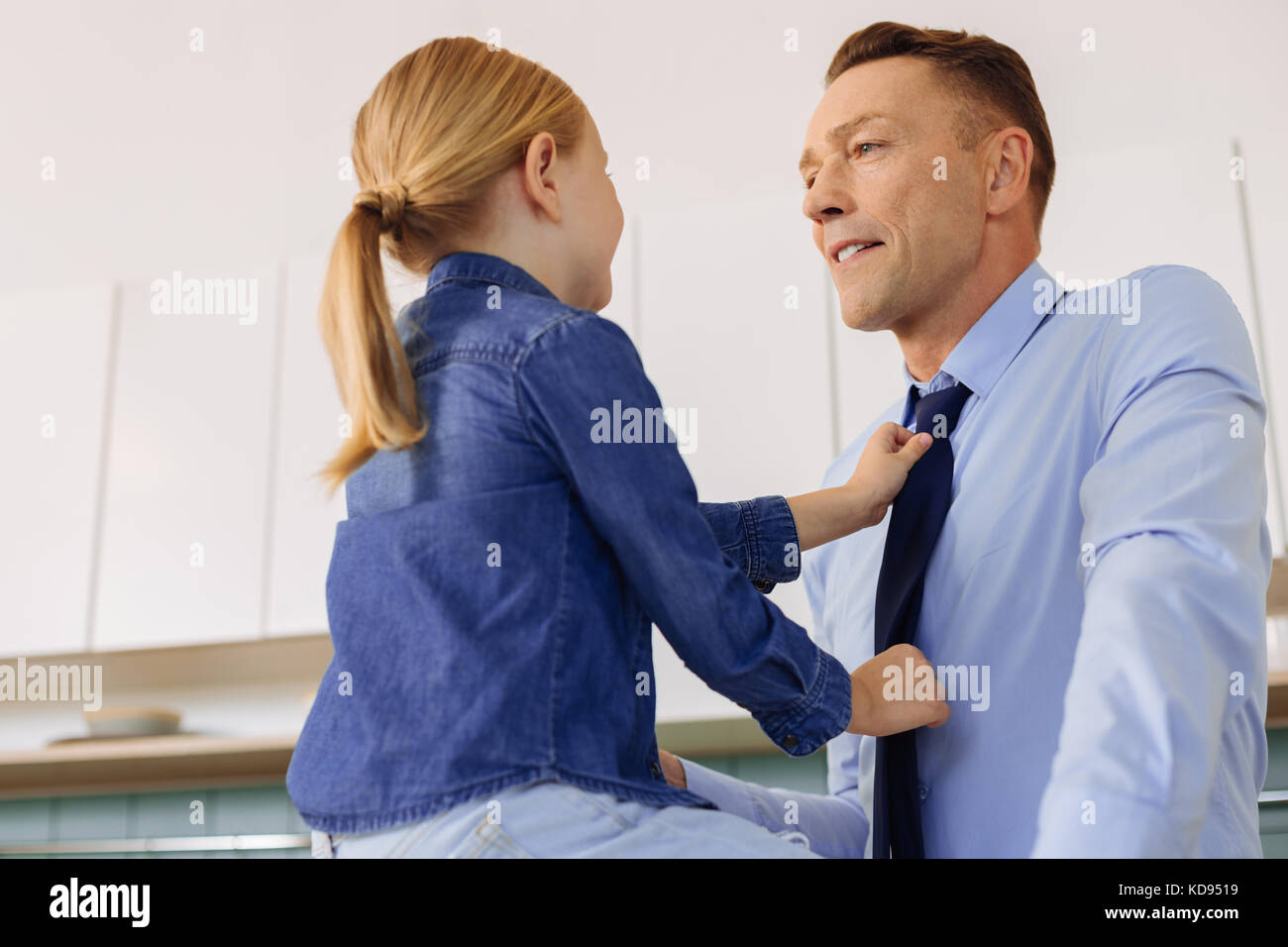 Delighted nice man having his tie fixed Stock Photo - Alamy