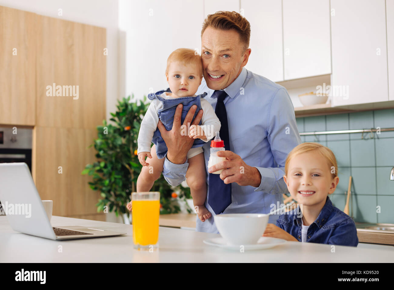 Delighted happy family looking at you Stock Photo - Alamy