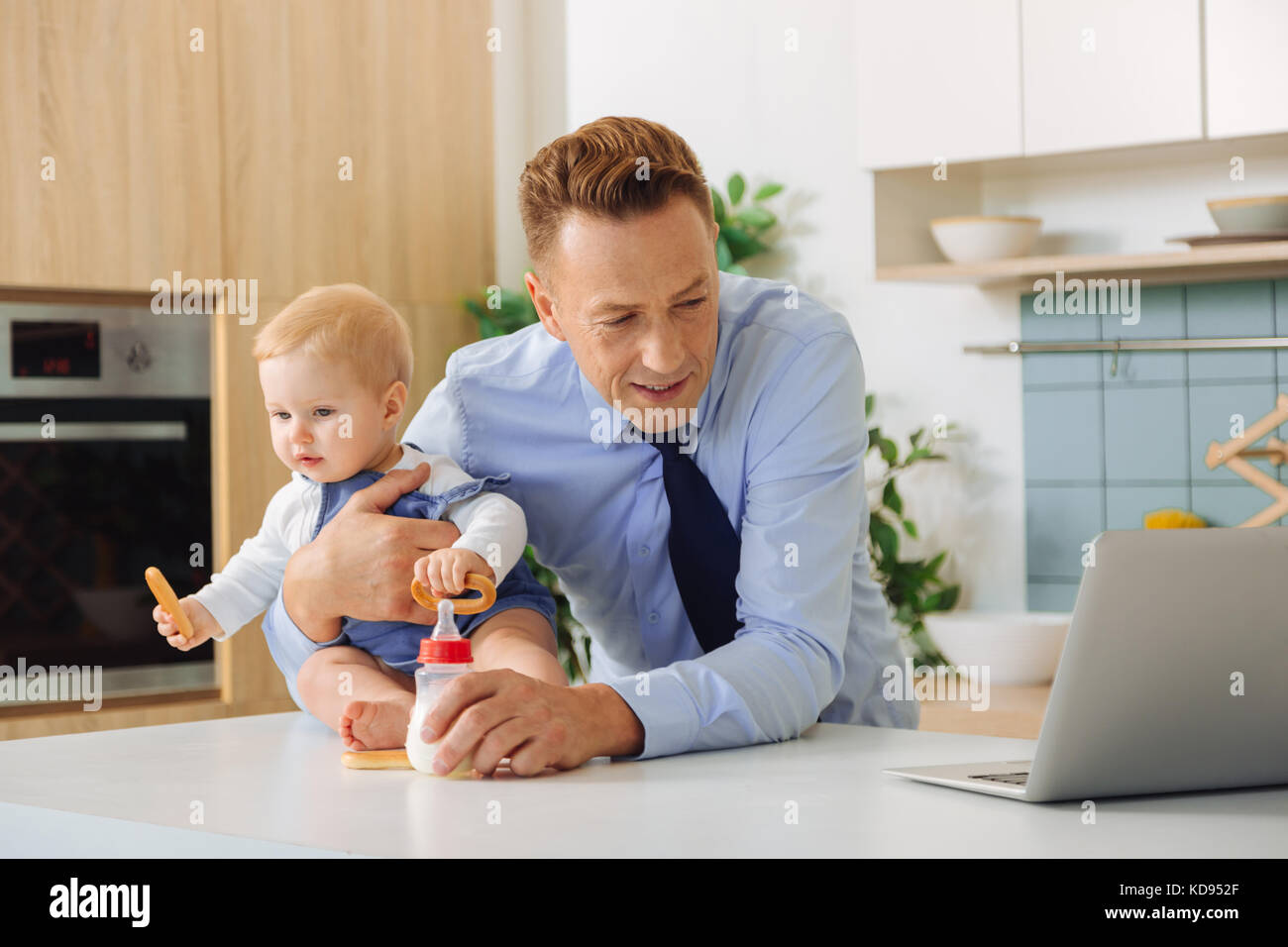 Pleasant nice man looking at the laptop screen Stock Photo - Alamy Pleasant nice man looking at the laptop screen Stock Photo - Alamy
