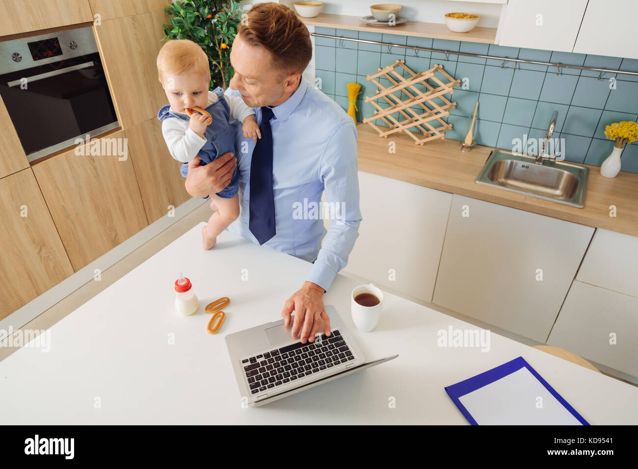 Delighted positive man standing in the kitchen Stock Photo - Alamy