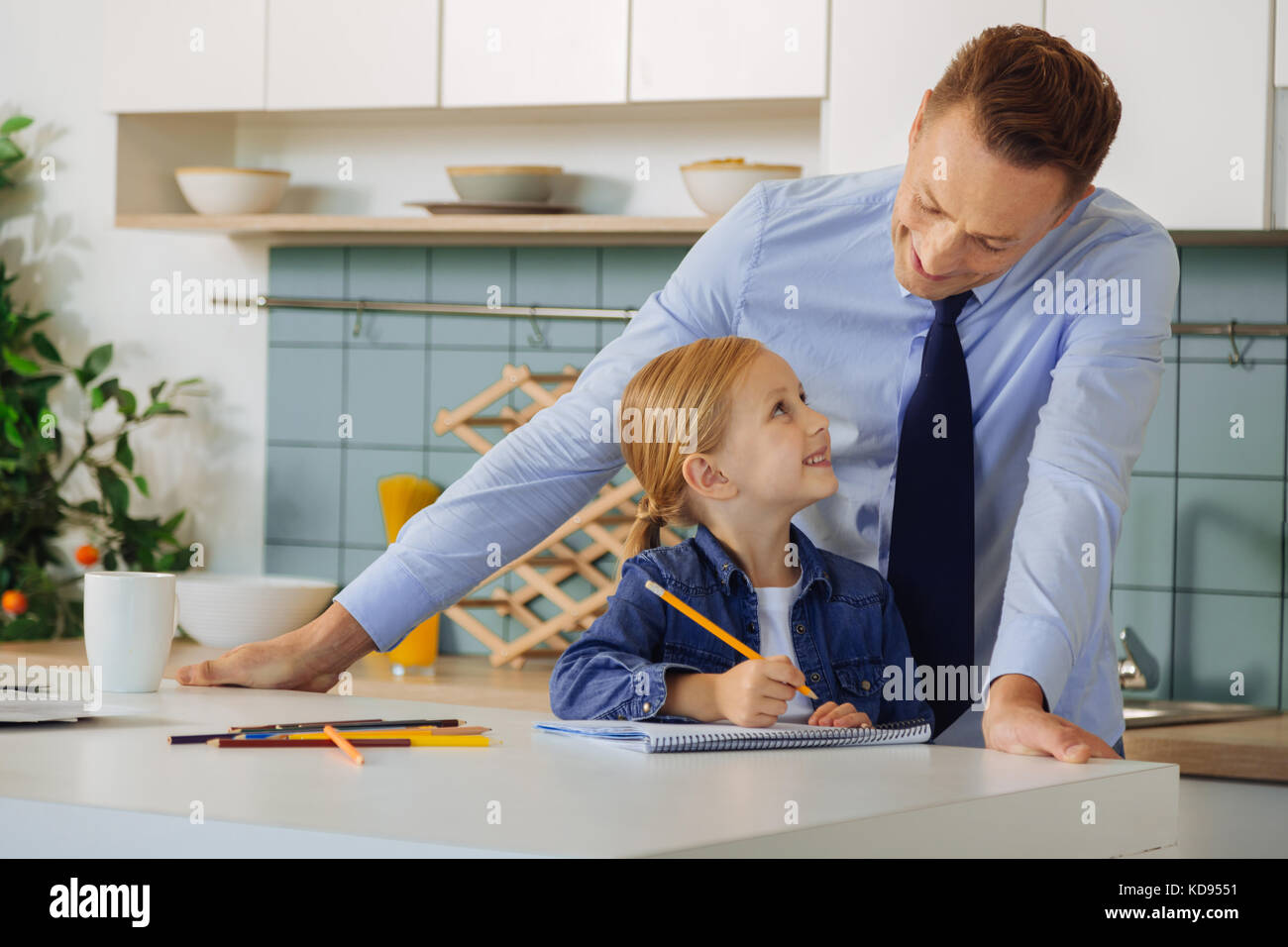 Delighted positive girl doing her homework Stock Photo - Alamy