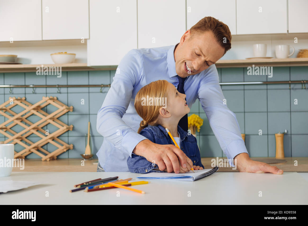 Smart nice father helping his daughter with studying Stock Photo - Alamy