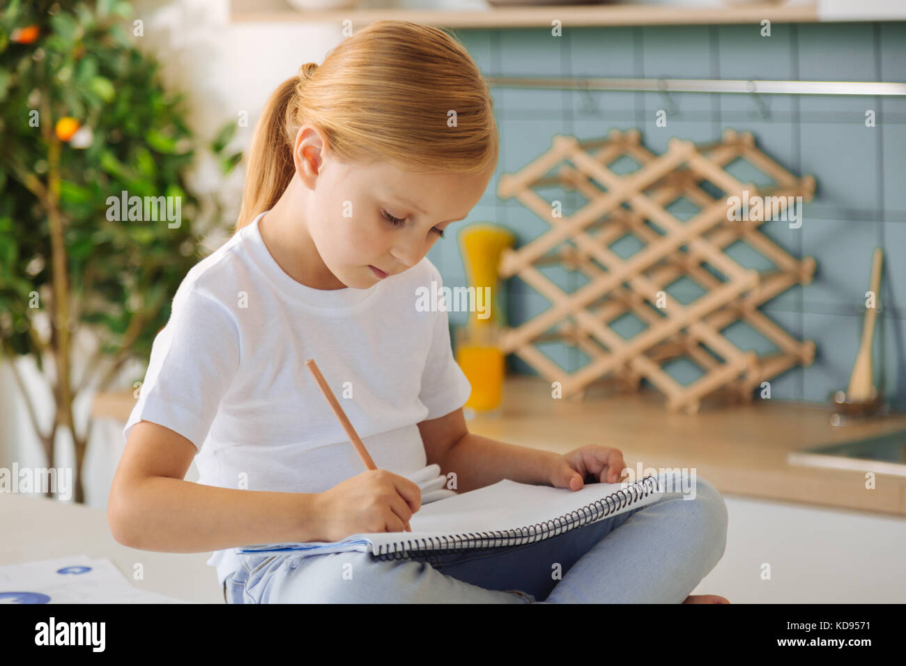 Serious talented girl doing a drawing Stock Photo - Alamy
