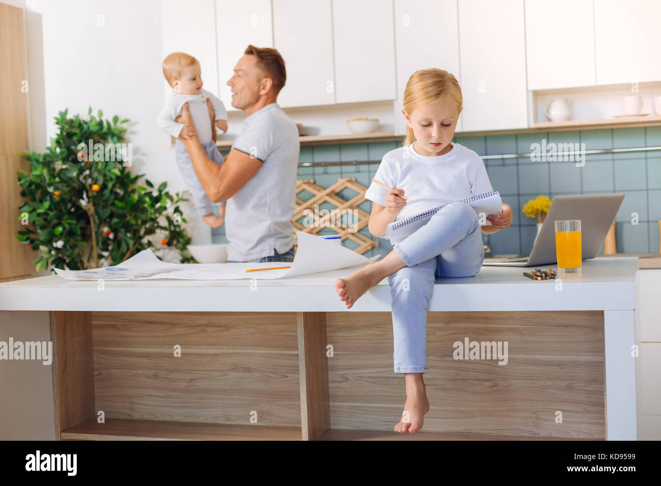 Serious smart girl being focused on drawing Stock Photo - Alamy