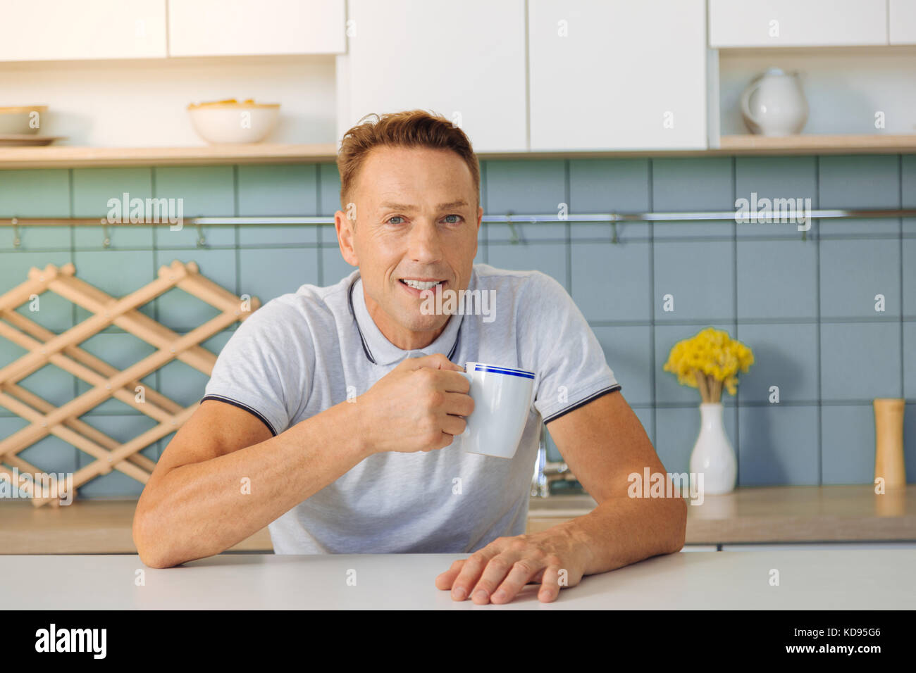Cheerful happy man enjoying his drink Stock Photo - Alamy