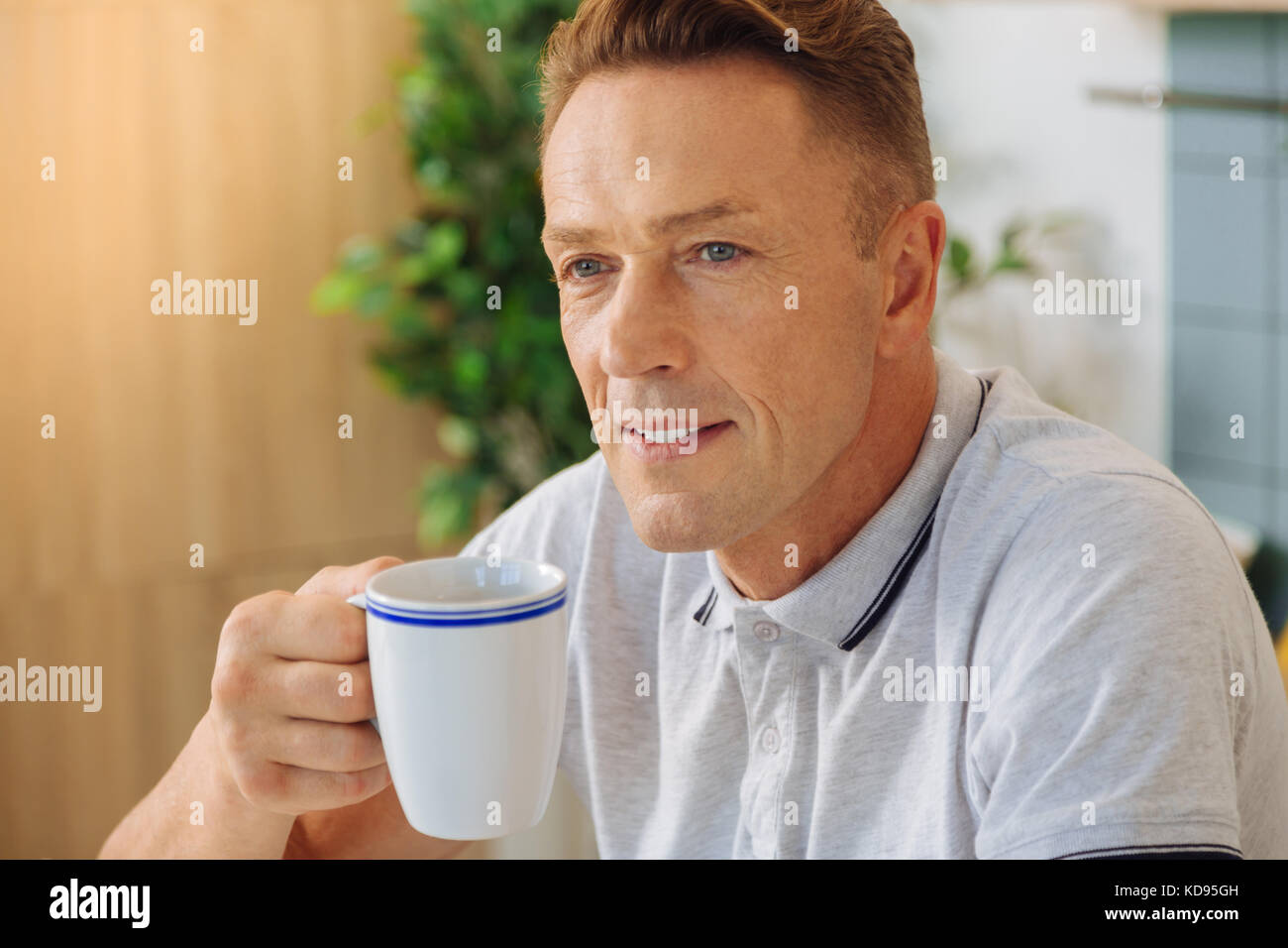 Serious handsome man enjoying his tea Stock Photo - Alamy