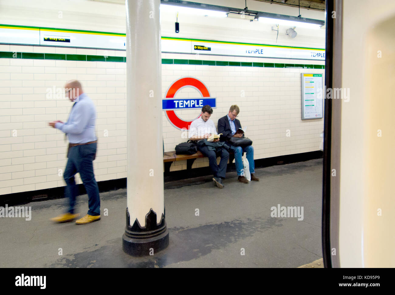 London, England, UK. Temple underground station - men on the platform ...