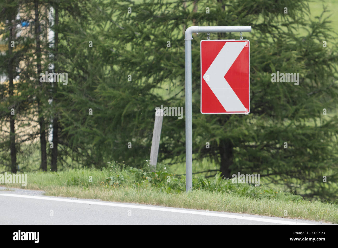 Sign at a corner on a road in the Austrian Alps Stock Photo - Alamy