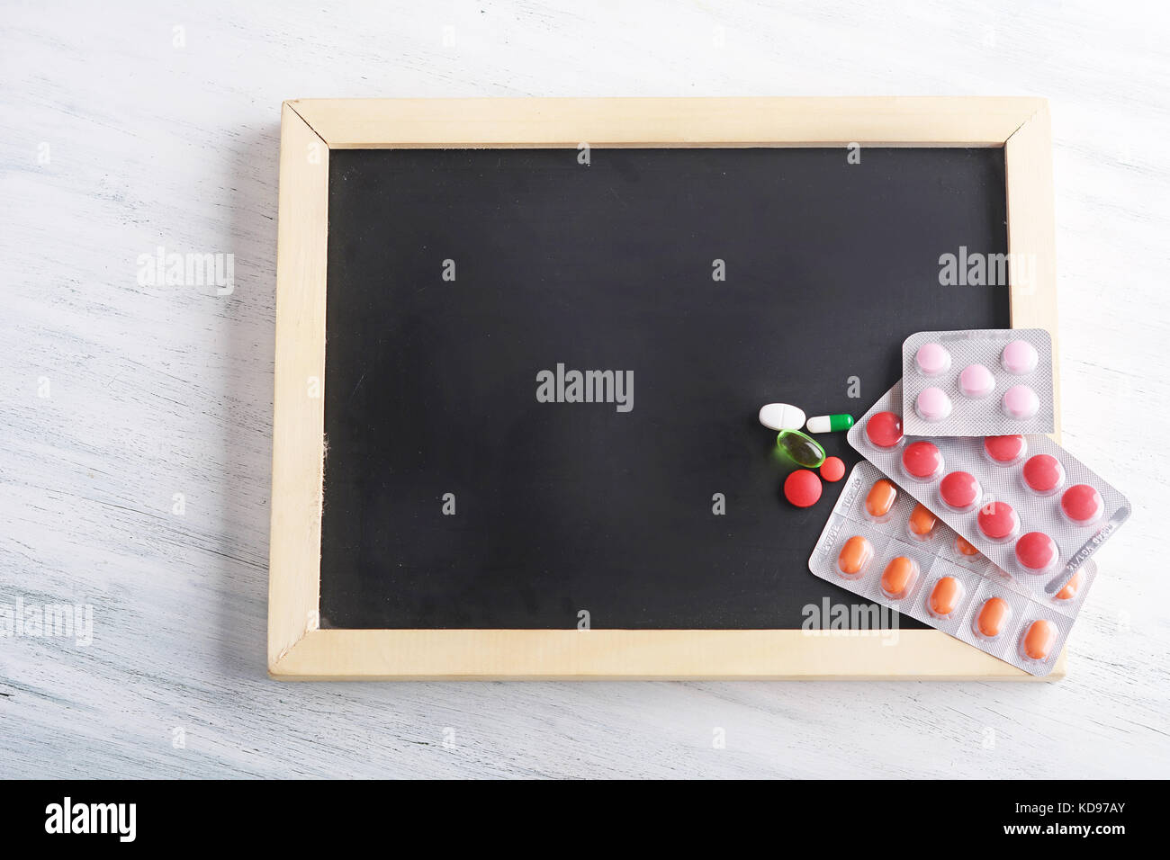 Close-up of empty chalkboard, pills and tablets. Healthcare concept ...