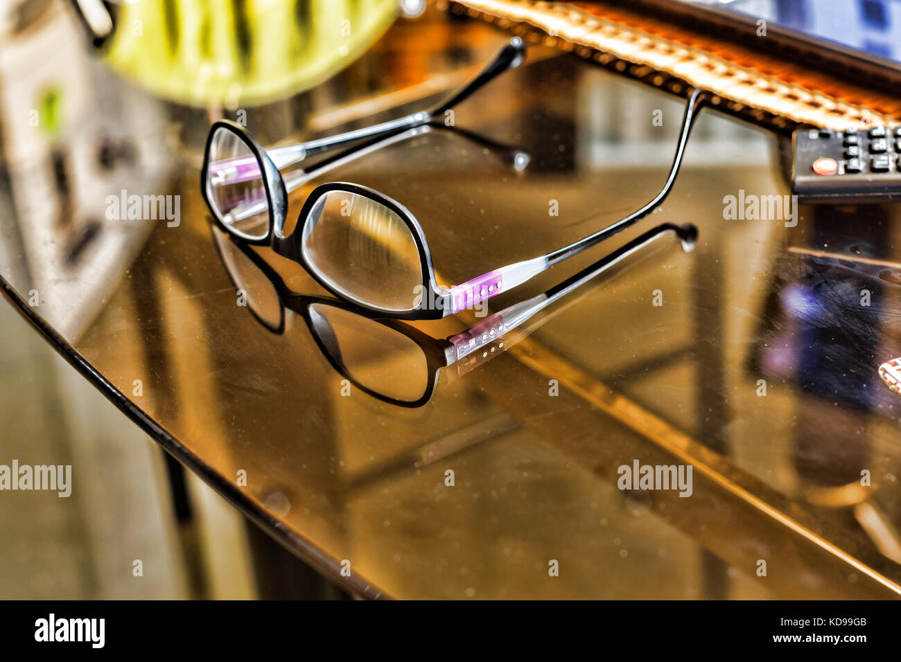 Glasses on a desk in the office. Glasses on a transparent desk in the ...