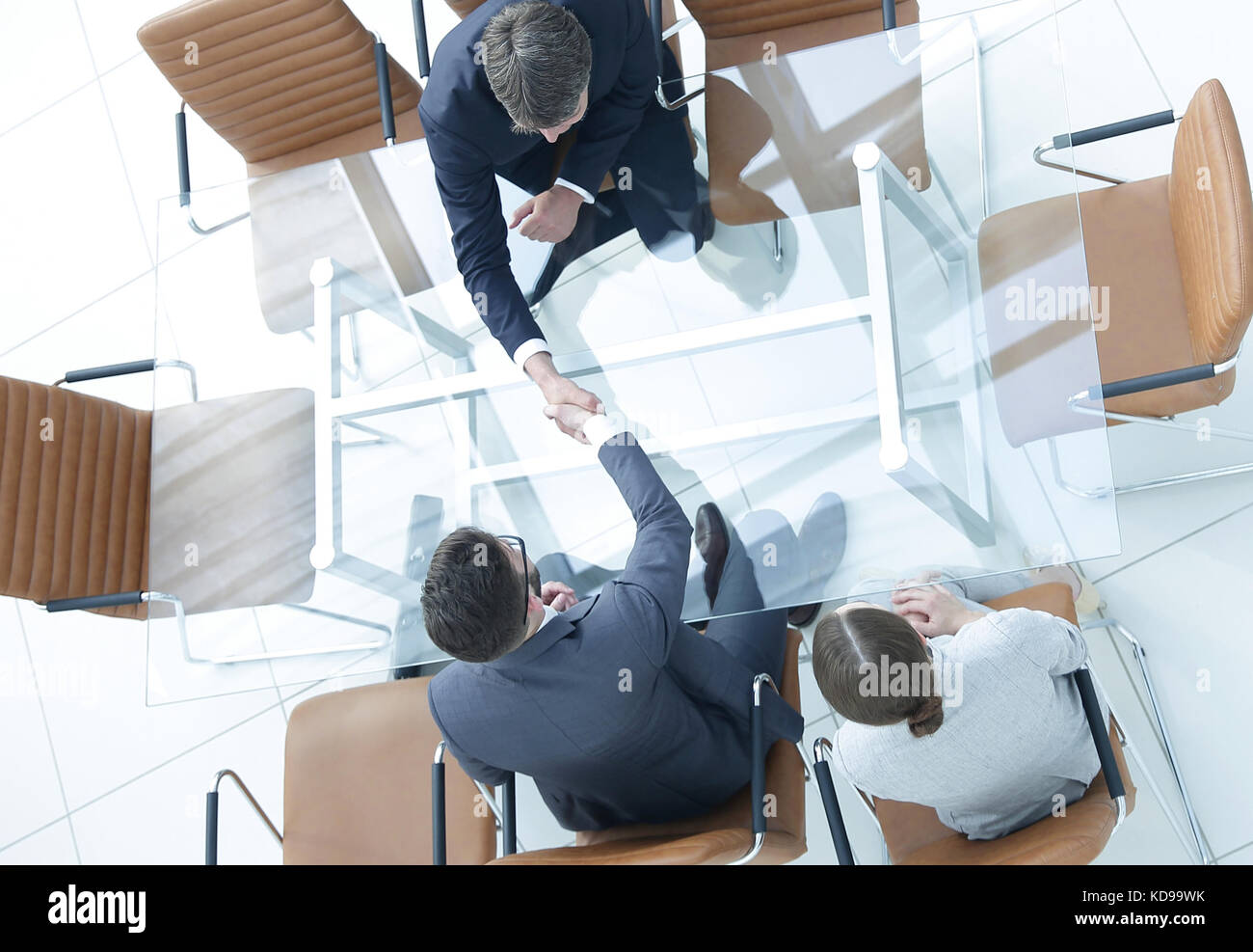 Handshake across the table. Meeting around a boardroom table Stock ...