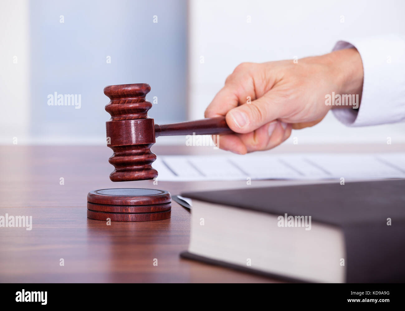 Male Judge In A Courtroom Striking The Gavel Stock Photo - Alamy