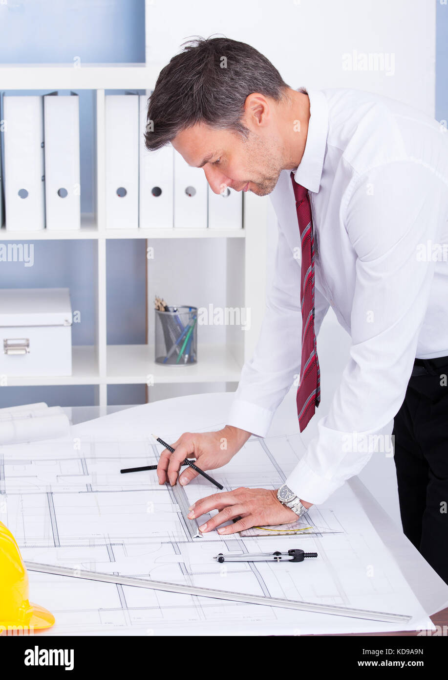Portrait Of Male Architect Drawing Blueprint In Office Stock Photo - Alamy