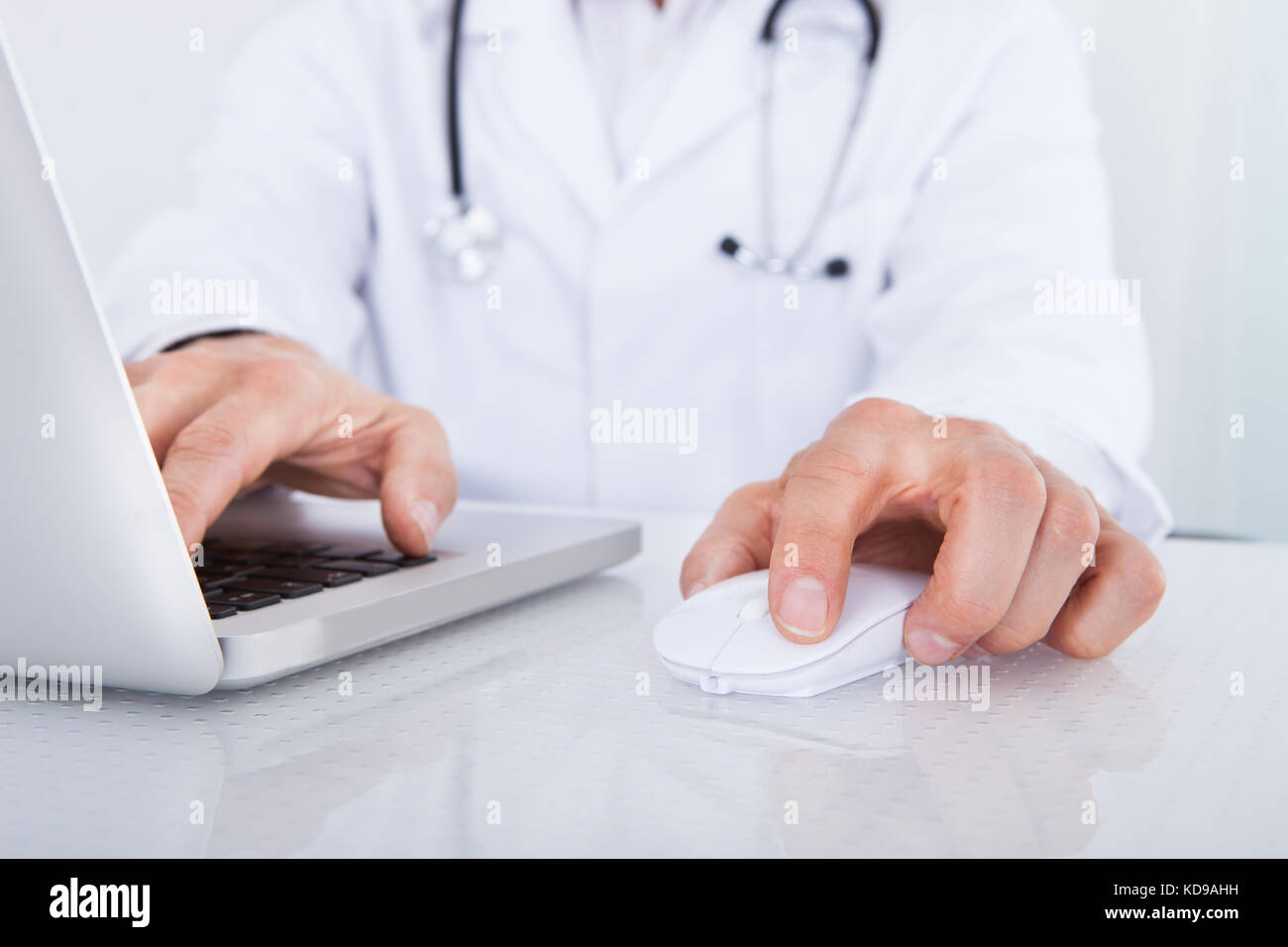 Close-up Of Doctor Using Laptop In Front Of Stethoscope At Desk Stock ...
