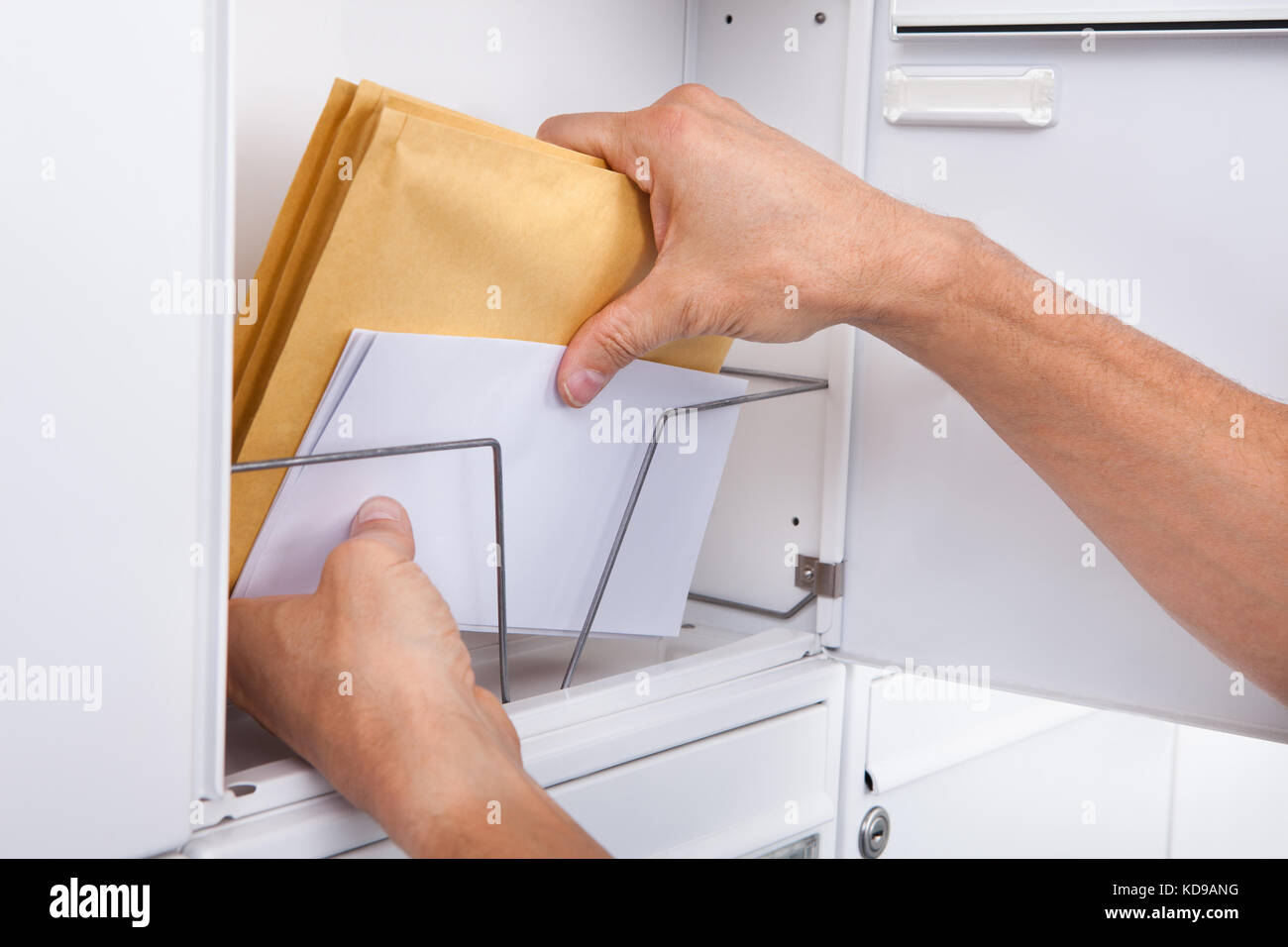 Close-up Of Postman's Hand Keeping Letters In Mailbox Stock Photo - Alamy