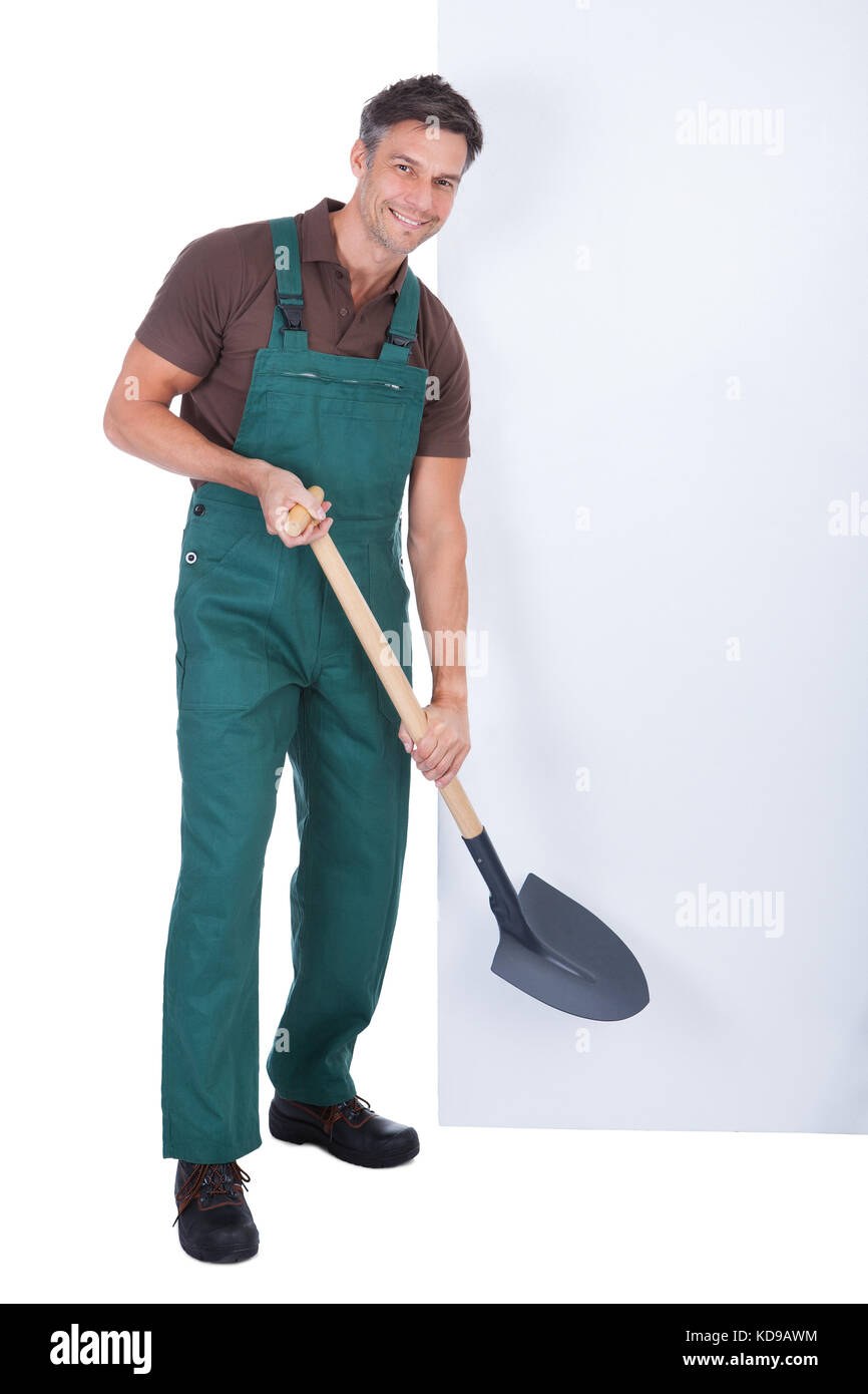 Portrait Of Cheerful Male Gardener With Shovel Presenting Blank Placard ...