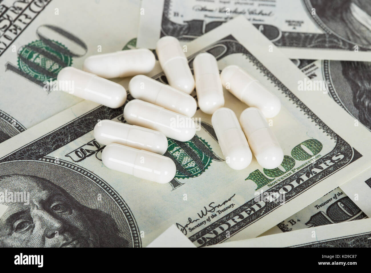 Medical drugs on top of american dollars Stock Photo - Alamy