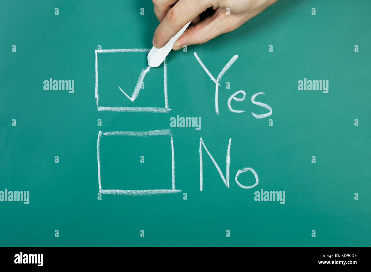 Hand holding chalk making a yes choice Stock Photo - Alamy