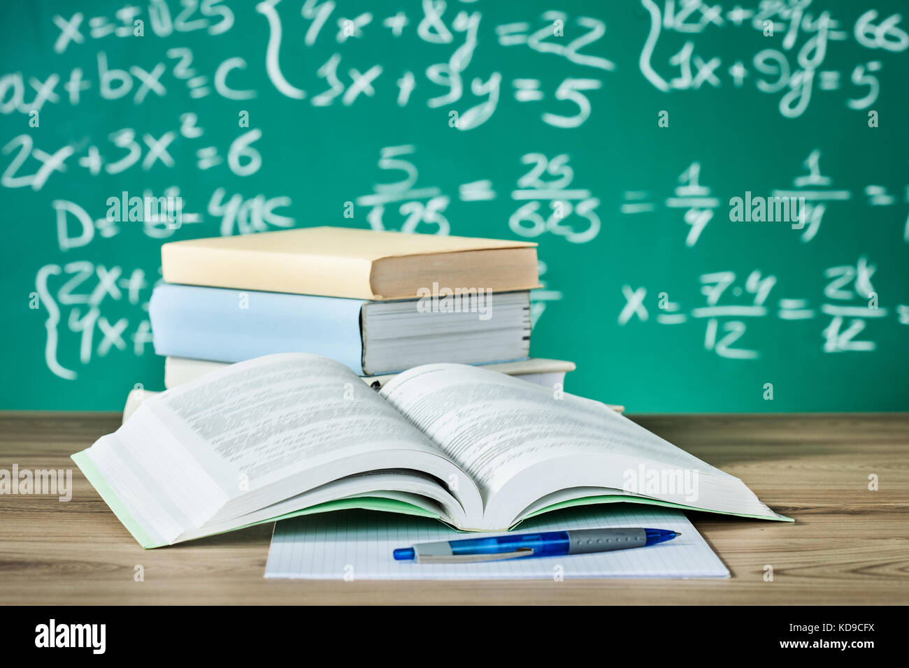 School textbooks on a desk in front of blackboard Stock Photo - Alamy