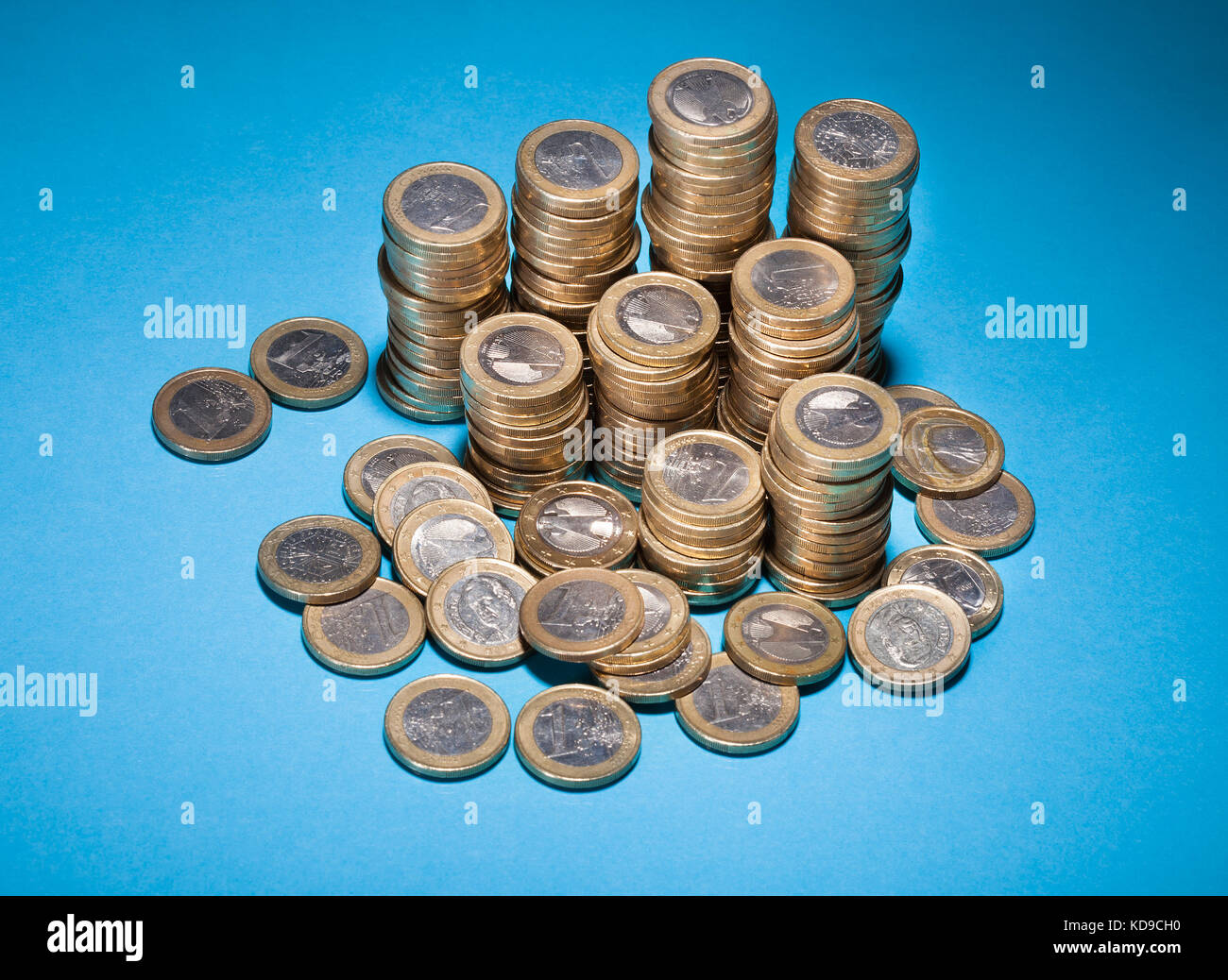 Stack Of Golden Coin Over Blue Background Stock Photo - Alamy
