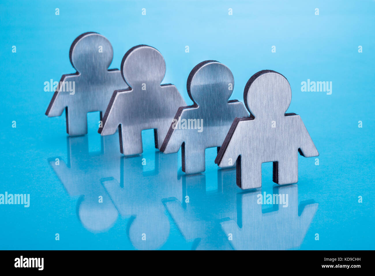 Cut Out Human Figure Of Metal Over Blue Background Stock Photo - Alamy