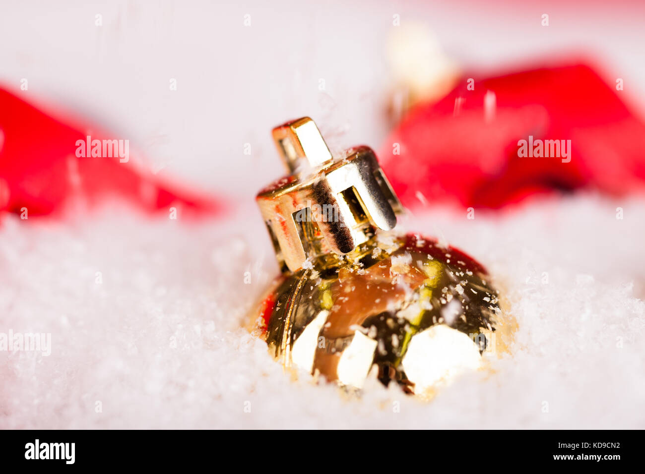 Close-up Of Golden Decorative Christmas Bauble In Snow Stock Photo - Alamy