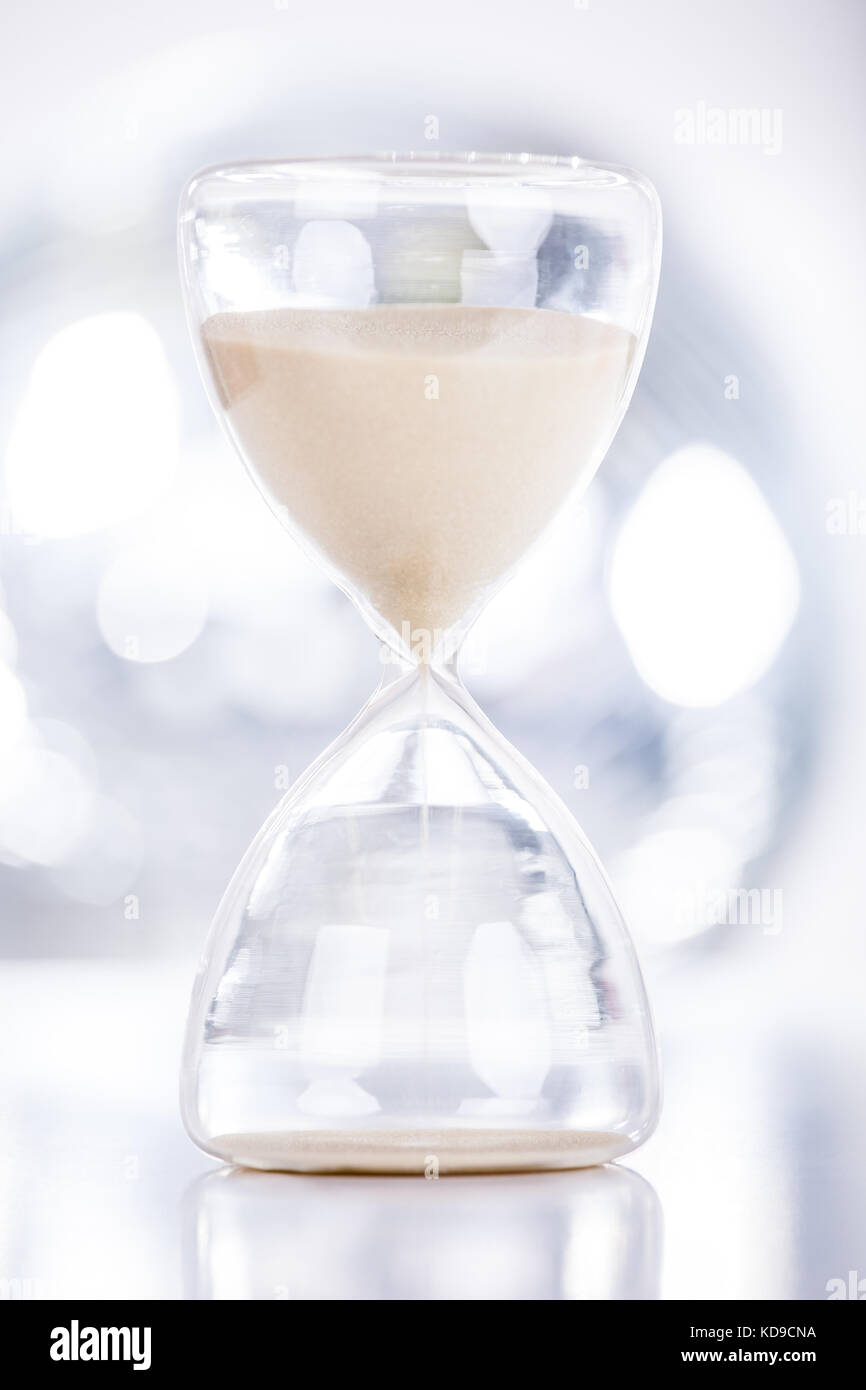 Close View Of Sand Flowing Through An Hourglass Stock Photo - Alamy