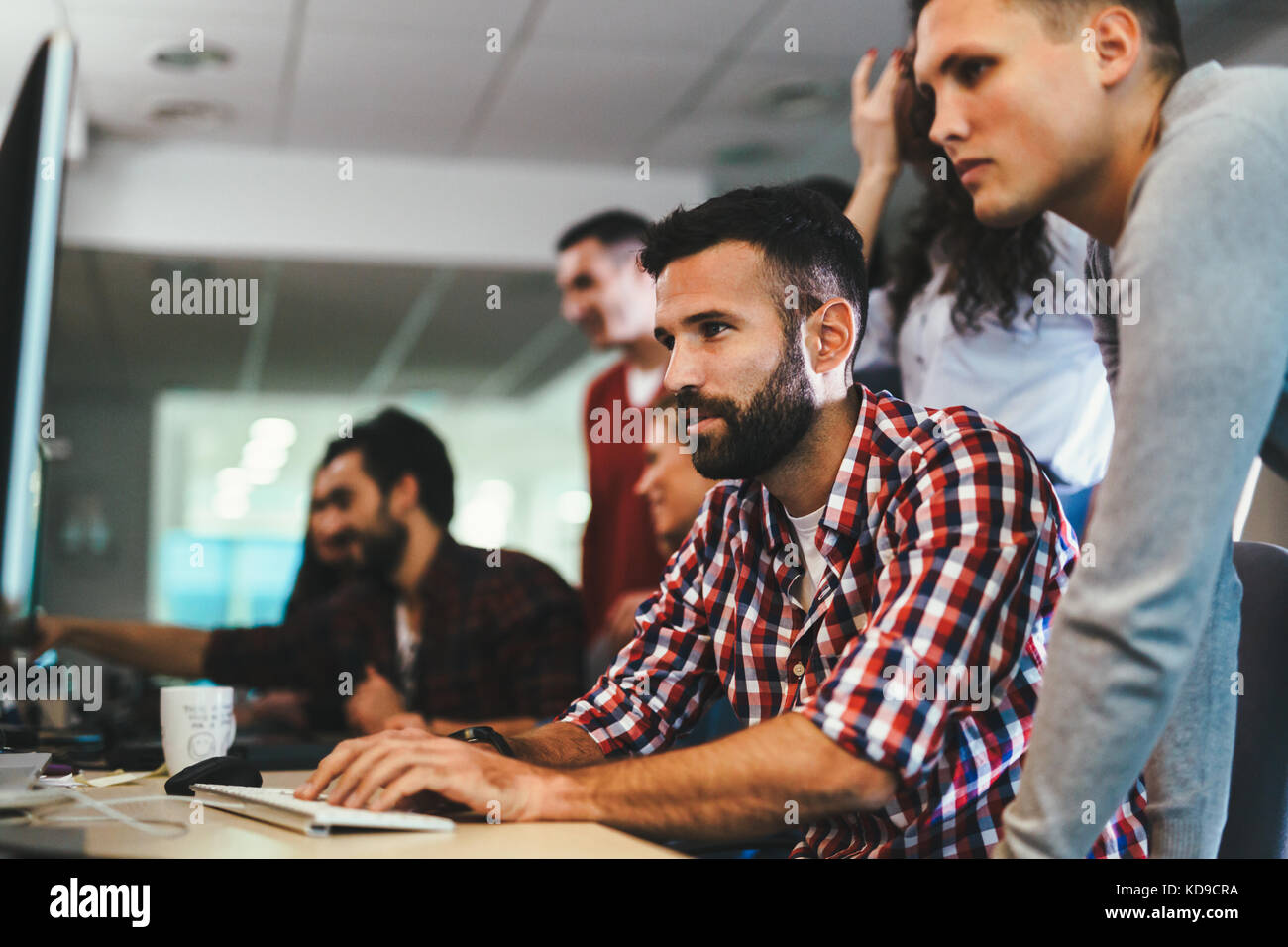 Portrait of programmers working in development software company Stock Photo - Alamy