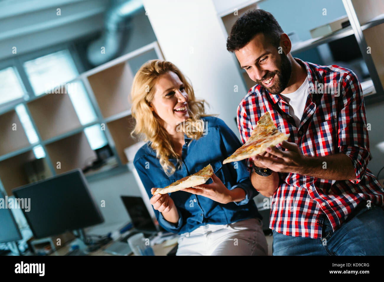 Software enginneers sharing pizza on break from work Stock Photo - Alamy