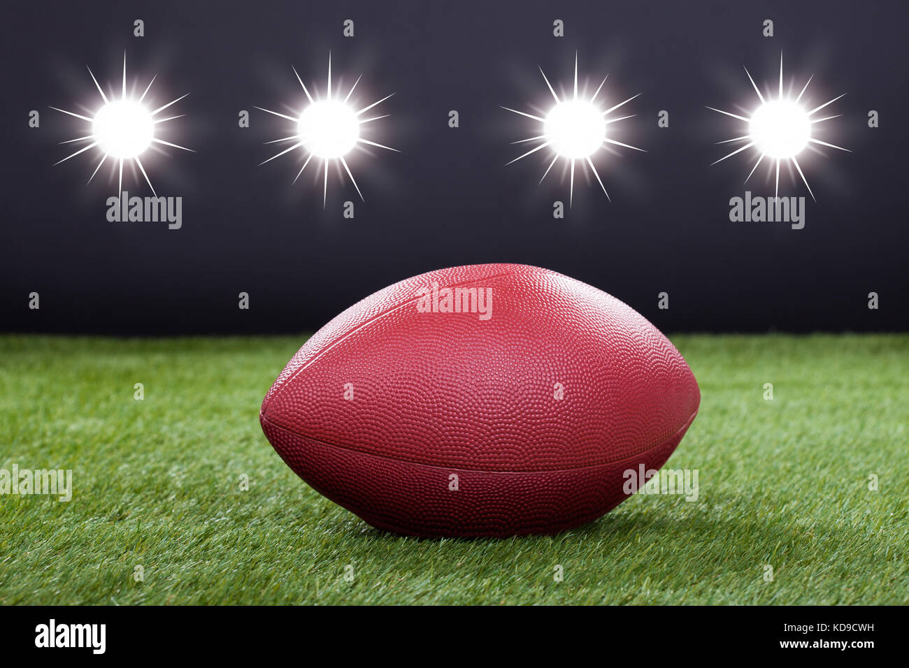 Red Leather Rugby Ball On Pitch Field Stock Photo - Alamy