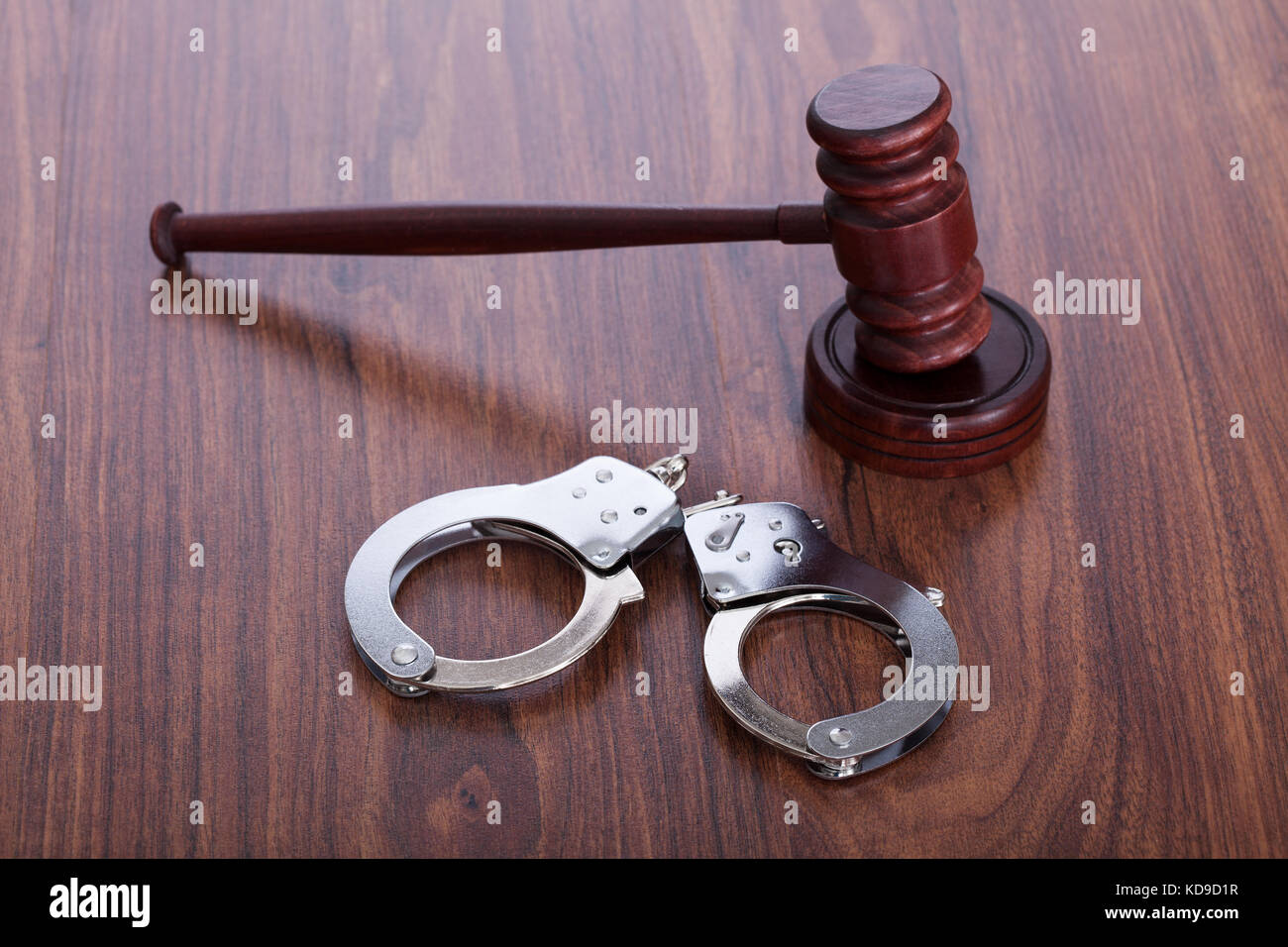 Photo Of Gavel And Handcuffs On Wooden Table Stock Photo - Alamy