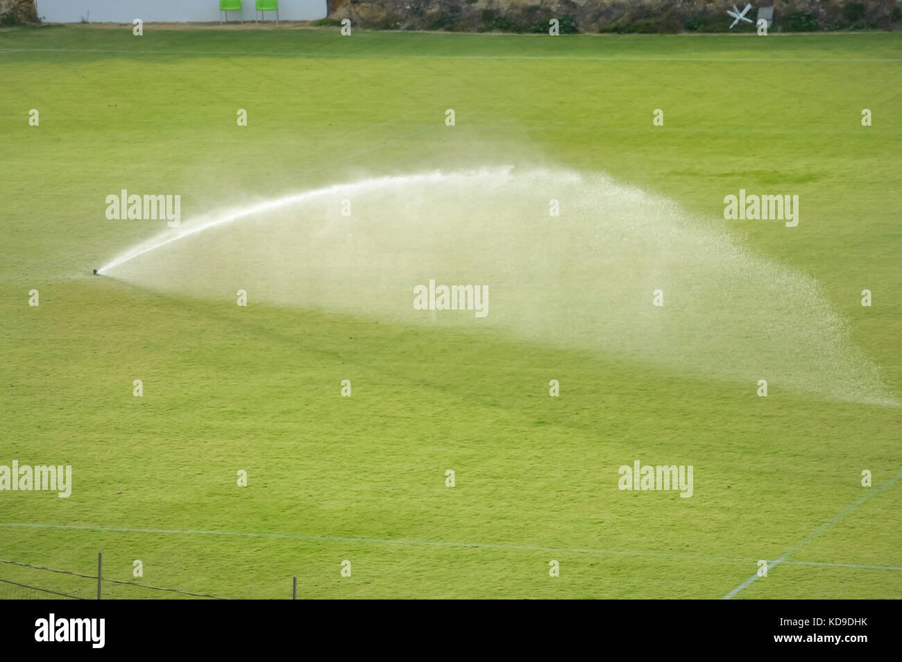 Automatic watering of a lawn in a football field Stock Photo - Alamy