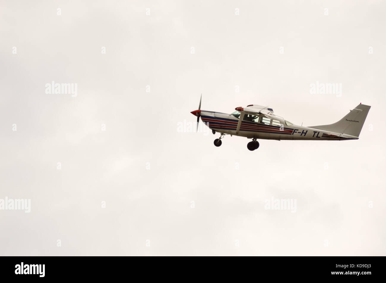 Small parachuting plane on a white background Stock Photo - Alamy