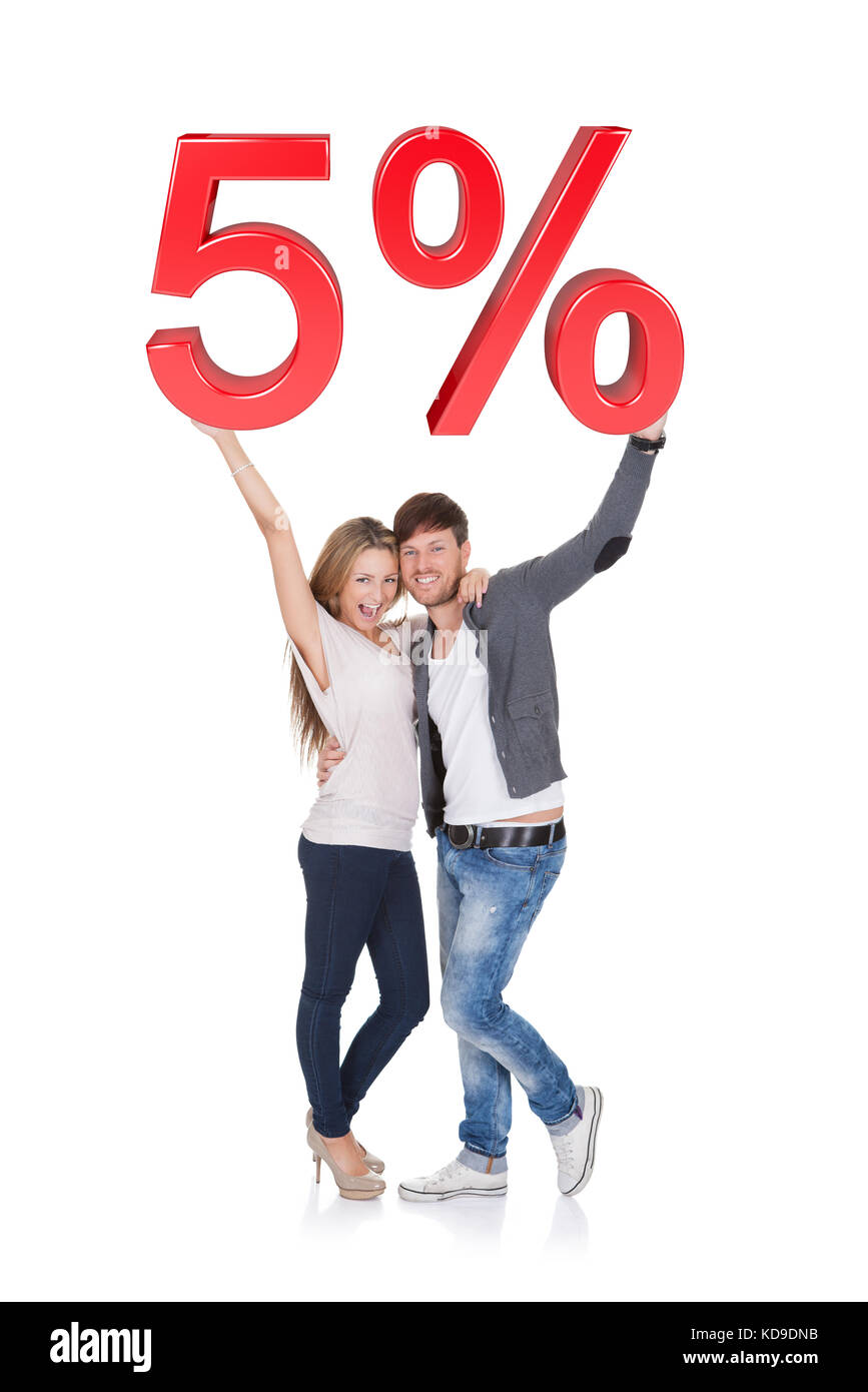 Happy young couple holding 5% sale sign. Isolated on white Stock Photo ...