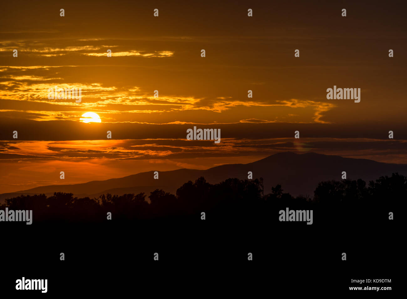 Beautiful sunset sky. Sky Background. The setting sun in a cloudy sky ...