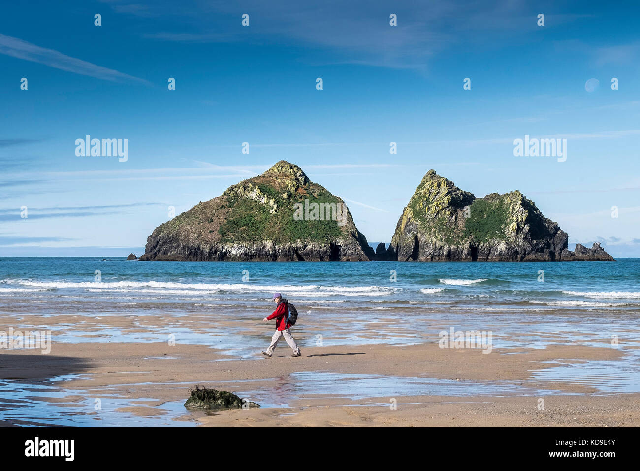 Holywell Bay Cornwall - a walker on the beach at low tide at Holywell ...