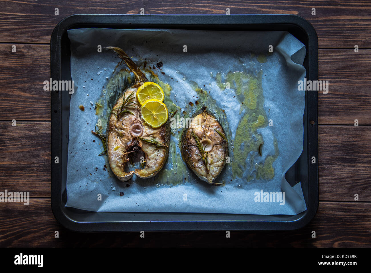 Grilled yellowtail amberjack with lemon slices on the cooking pan Stock ...
