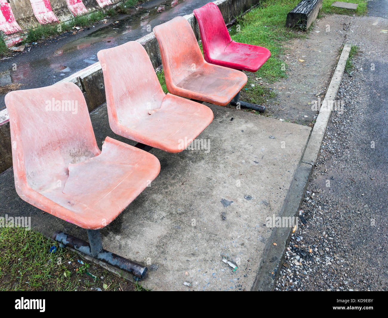 Old plastic chair on the metal row for passenger in the railway station ...