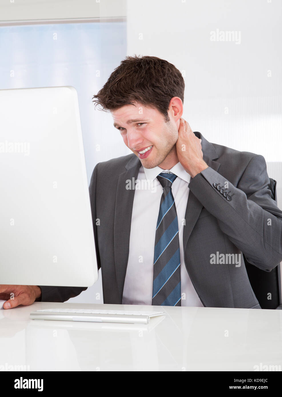 Young Businessman Using Computer Suffering From Neck Ache Stock Photo ...