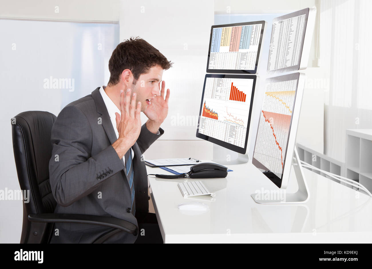 Portrait Of Young Businessman Using Computer At Desk Stock Photo - Alamy