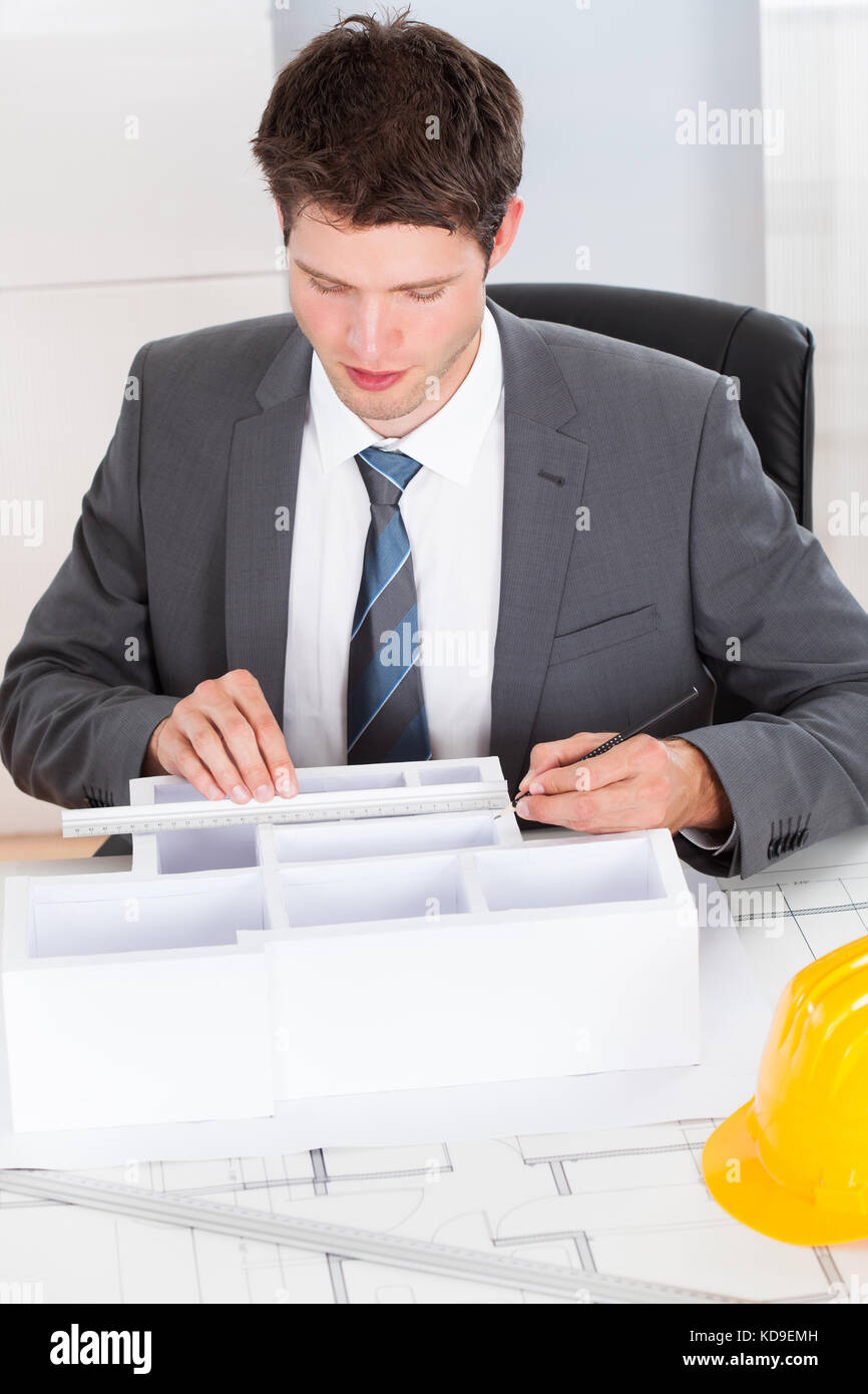 Close-up Of A Male Architect Measuring House Model With Scale Stock ...