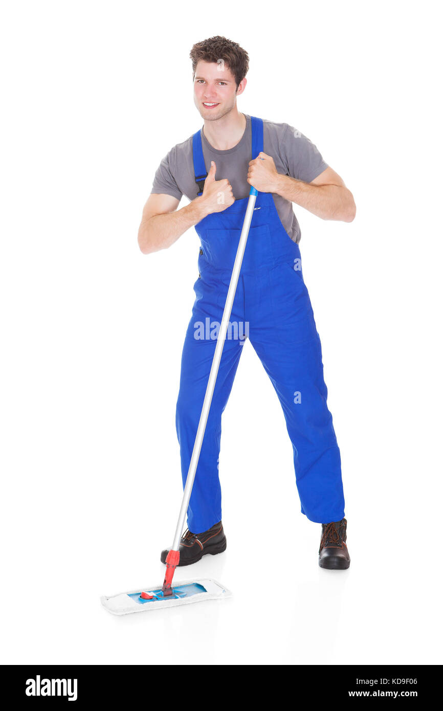 Young Man In Blue Uniform Cleaning The Floor Over White Background ...