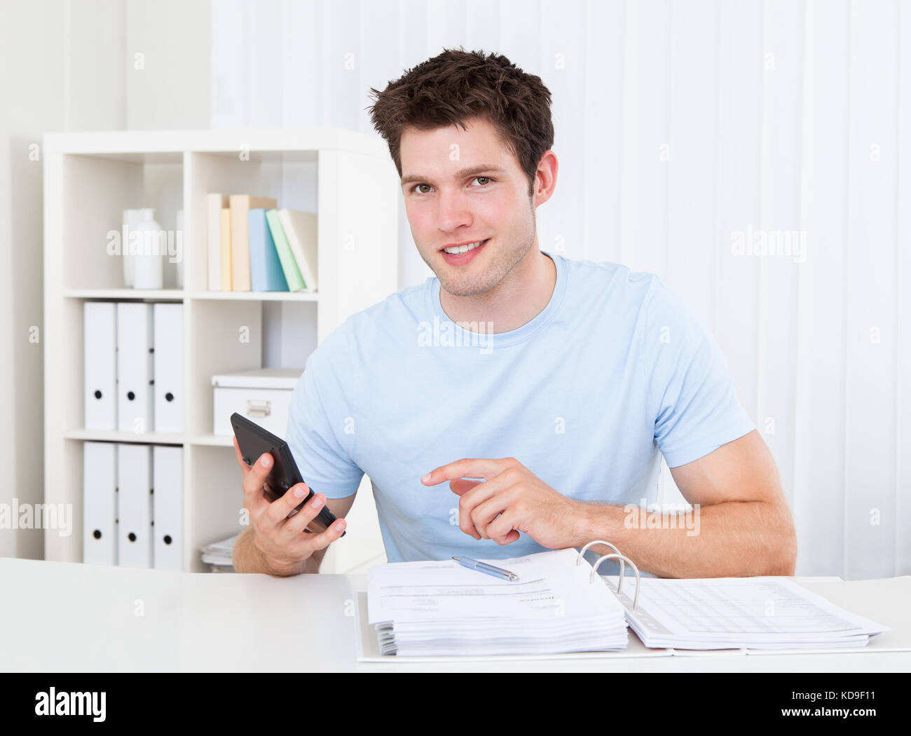 Young Man Calculating His Finance Expenses At Home Stock Photo - Alamy Young Man Calculating His Finance Expenses At Home Stock Photo - Alamy