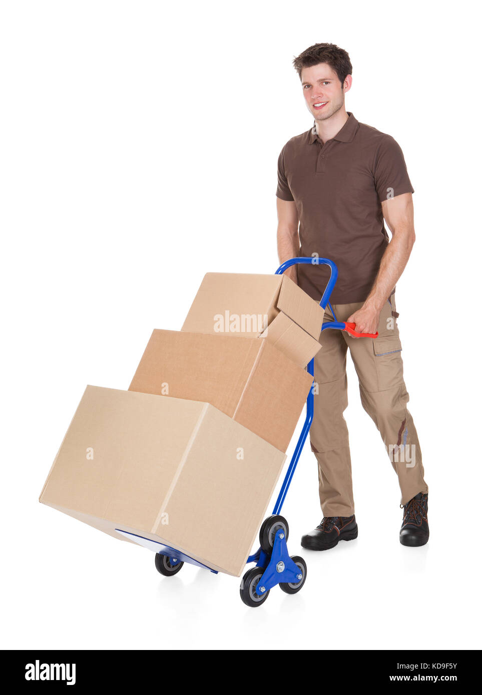 Young Happy Delivery Man Carrying Boxes On A Hand Truck Stock Photo - Alamy