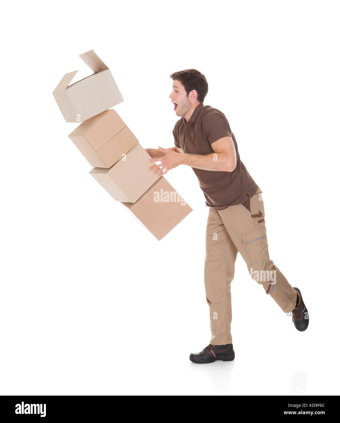 Young Delivery Man Dropping Stack Of Cardboard Boxes Stock Photo - Alamy