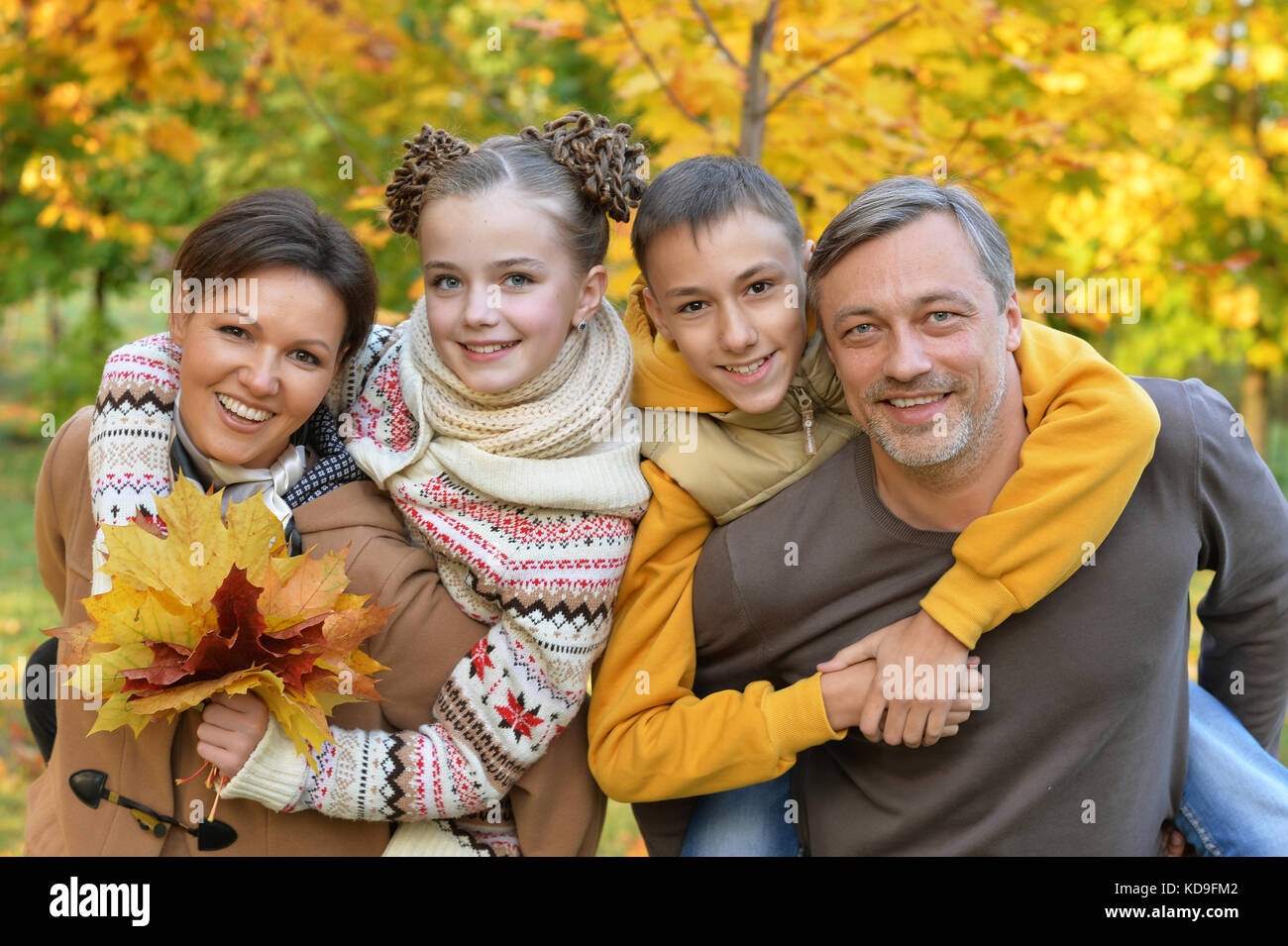 Happy family in park Stock Photo - Alamy