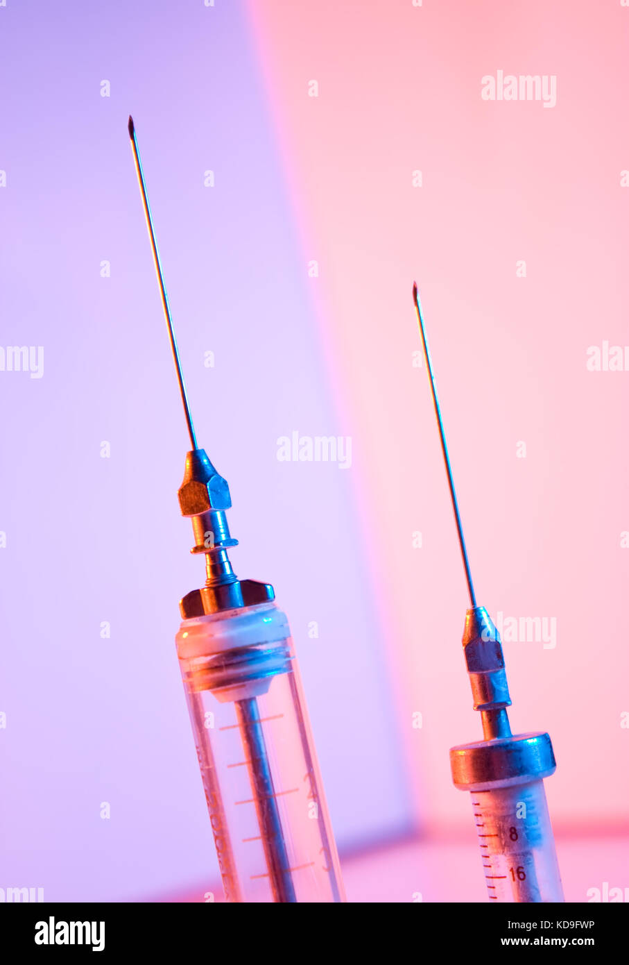 old glass syringe multicolored lights Stock Photo - Alamy