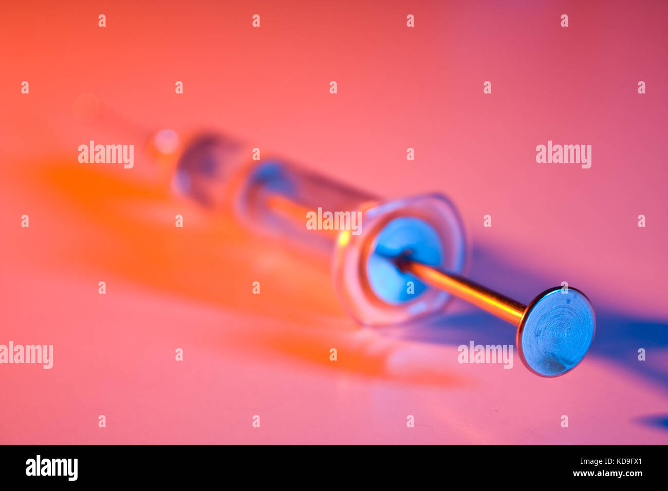 old glass syringe multicolored lights Stock Photo - Alamy