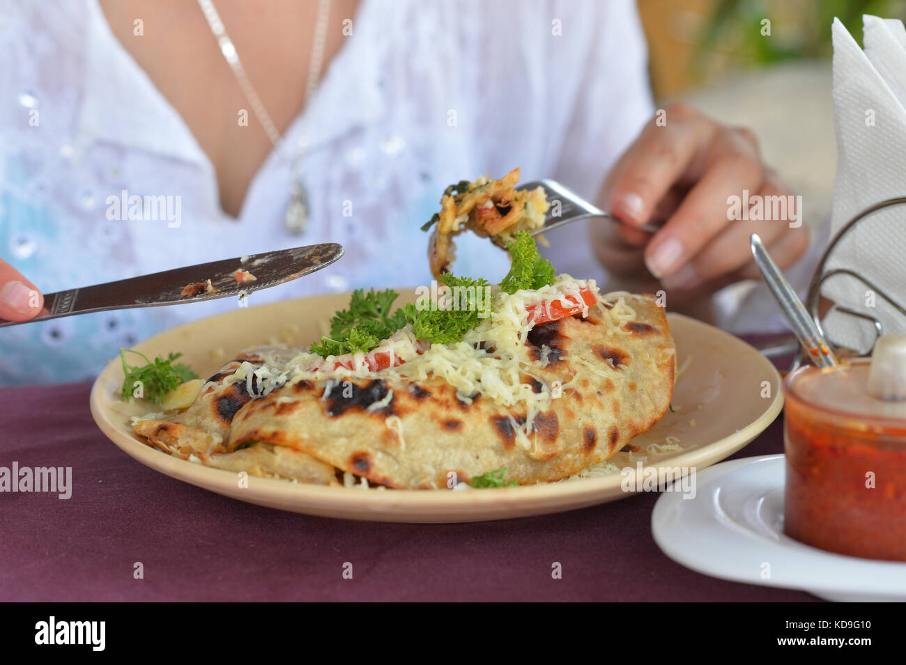 Woman eating at cafe Stock Photo - Alamy