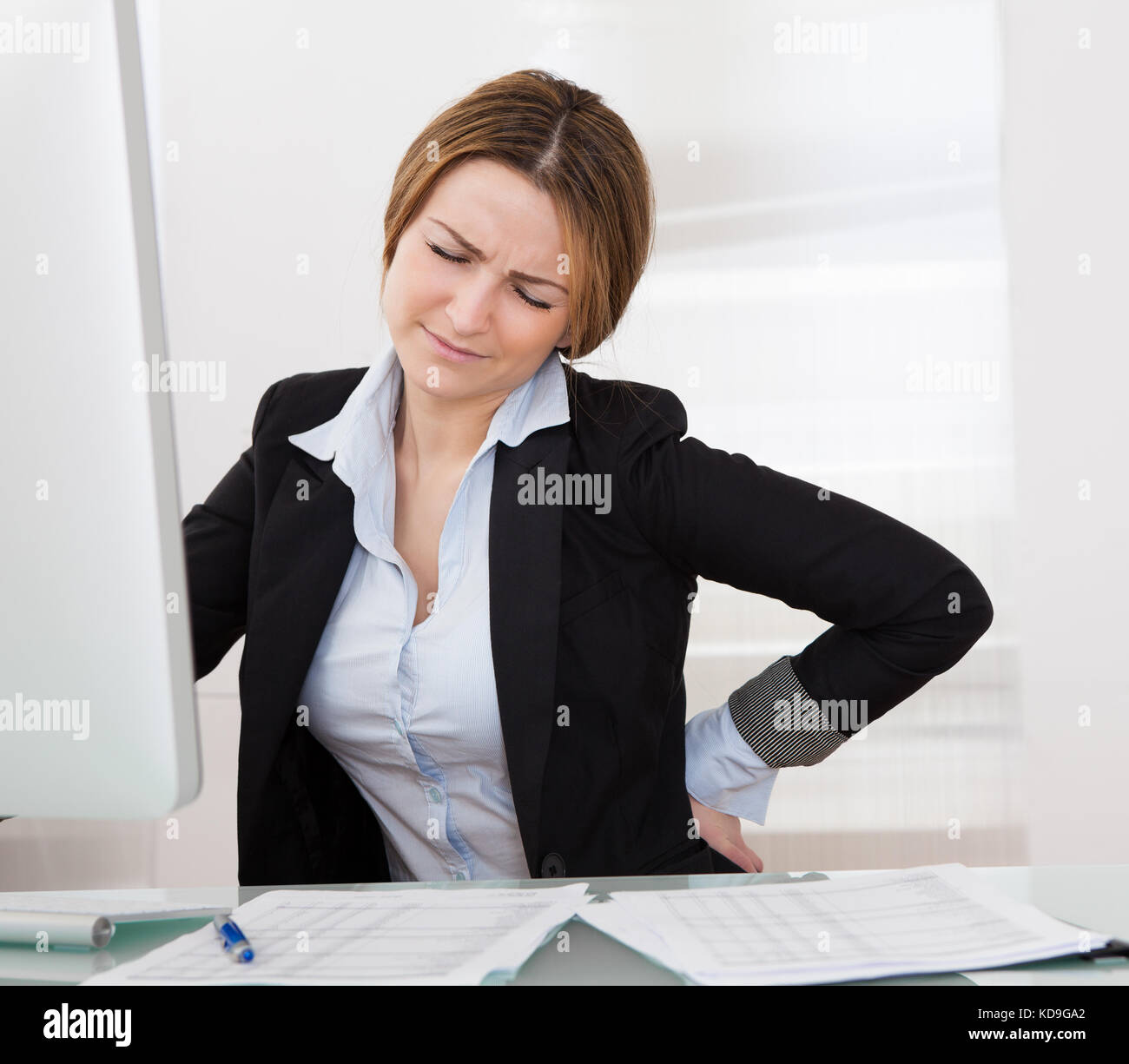 Business Woman With Back Pain Holding Her Aching Hip Stock Photo - Alamy